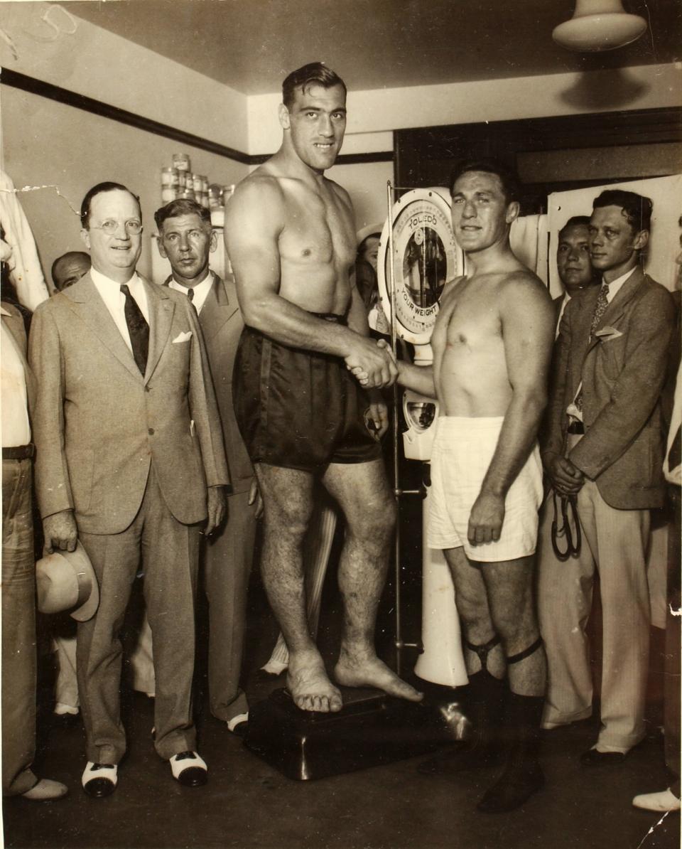 Unidentified boxing figures surrounding boxer on scale | Smithsonian ...