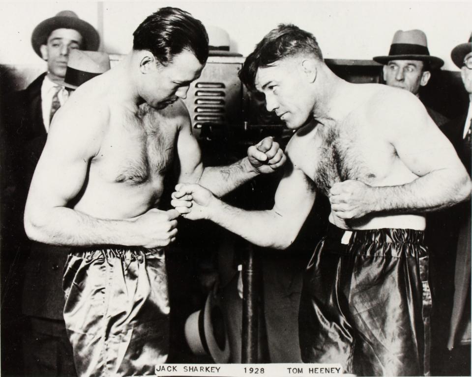Jack Sharkey (left) and Tom Heeney (right) surrounded by unidentified ...